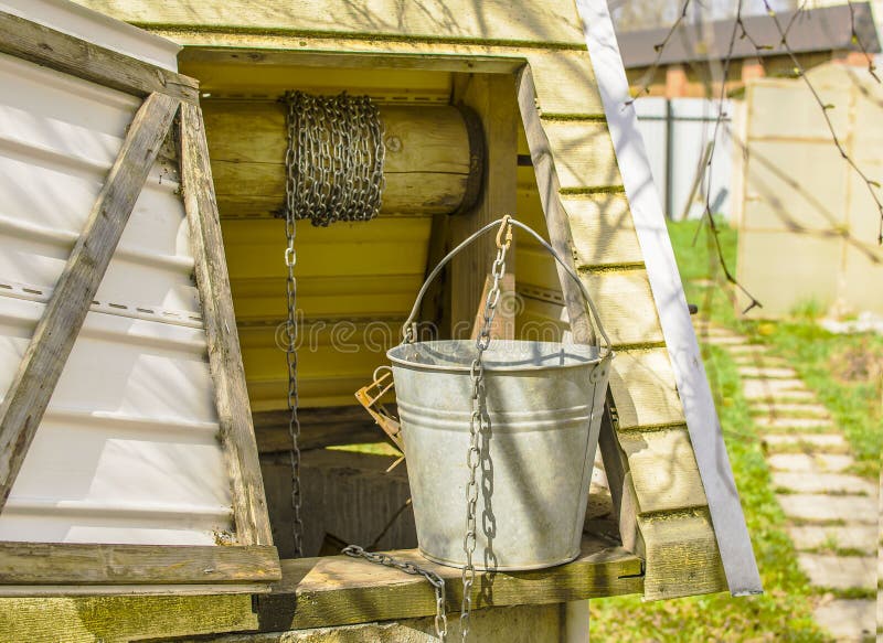 Bucket with a Chain Stands on the Old Well Stock Image - Image of chain ...