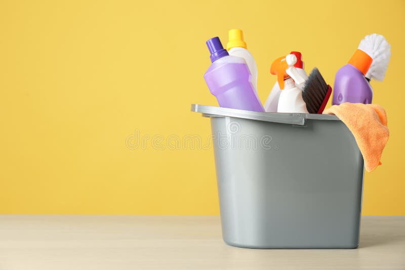 Bucket with Cleaning Products and Tools on Grey Table. Space for Text ...