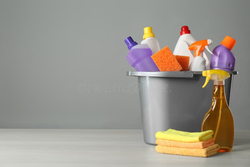 Bucket with Cleaning Products and Tools on Grey Table. Space for Text ...