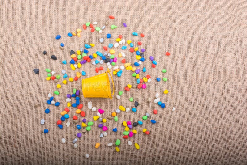 Bucket of Colorful Pebbles Spill on Canvas Background Stock Photo ...