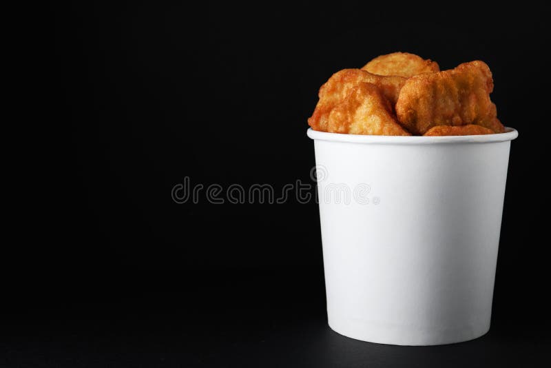 Bucket with Delicious Chicken Nuggets on Background. Space for Text ...