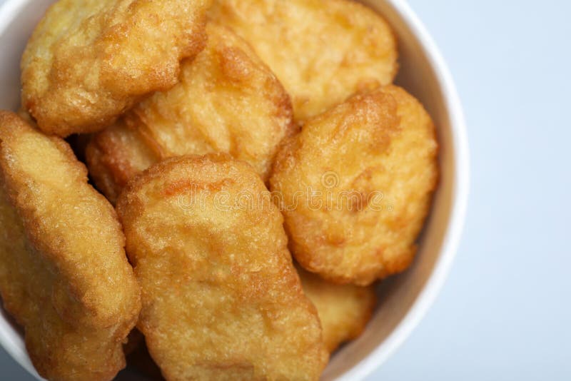 Bucket with Delicious Chicken Nuggets on Background, Closeup Stock ...