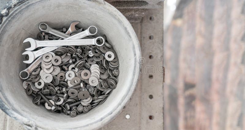 A Bucket Full of Wrenches, Washers and Stud Bolts is Placed on the ...