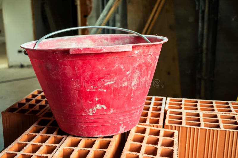 Bucket on hollow bricks stock photo. Image of architect - 24547448