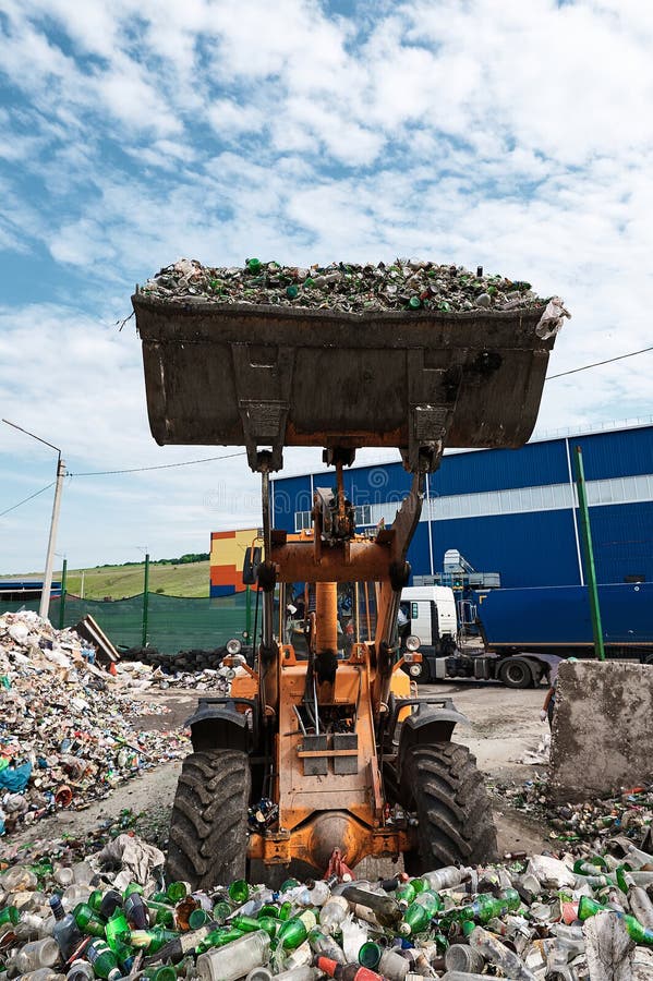 The Bucket Loader Breaks Glass Bottles by Dumping Them Out of the ...