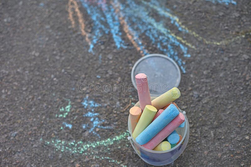 A Bucket of Multi-colored Chalk on the Asphalt in a Plastic Box Stock ...