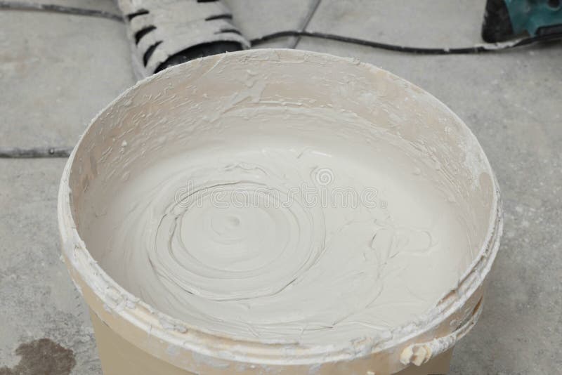 Bucket with Plaster on Concrete Floor Indoors, Closeup Stock Photo ...
