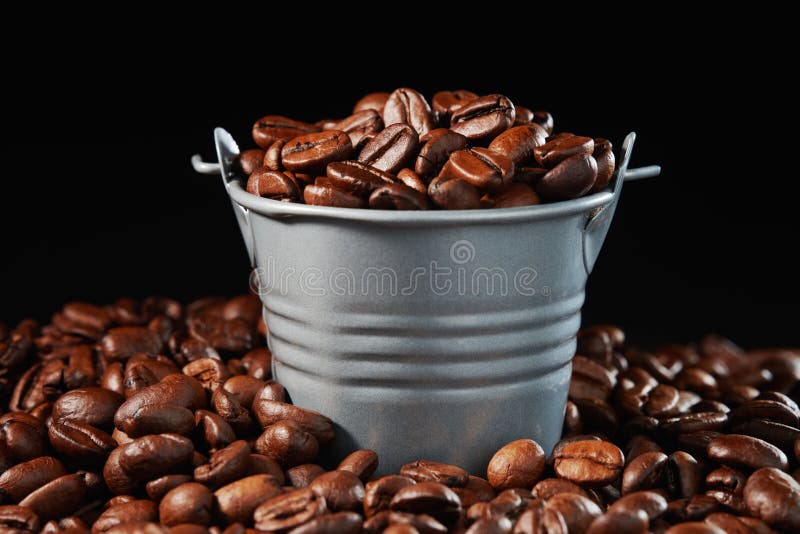 A Bucket of Roasted Coffee Beans in a Pile of Coffee Beans on a Black ...
