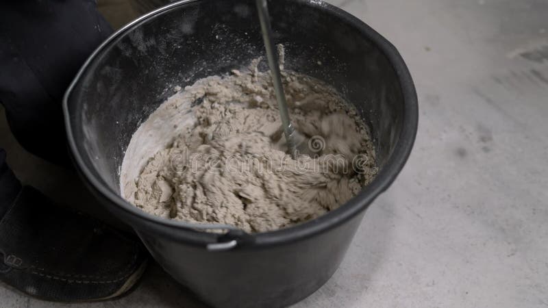 A Bucket with a Solution is Mixed with a Construction Mixer. we Mix the ...