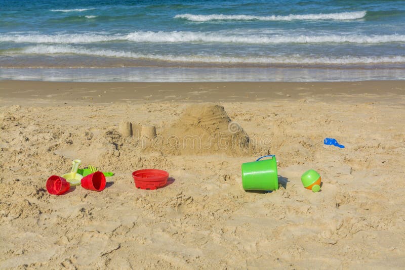 Bucket and spade on beach stock photo. Image of beach - 60909540