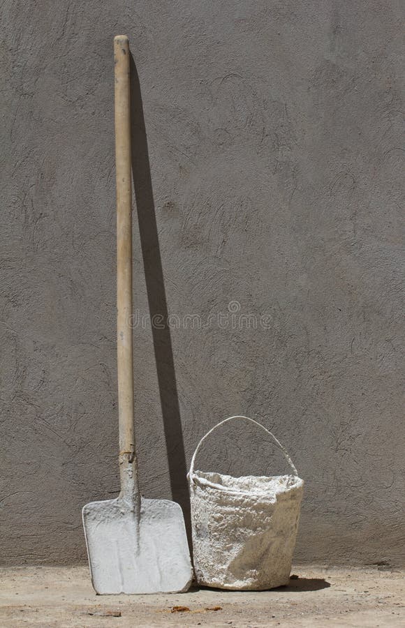 Bucket and Spade on a Background of Brick and Concrete Wall Stock Photo ...