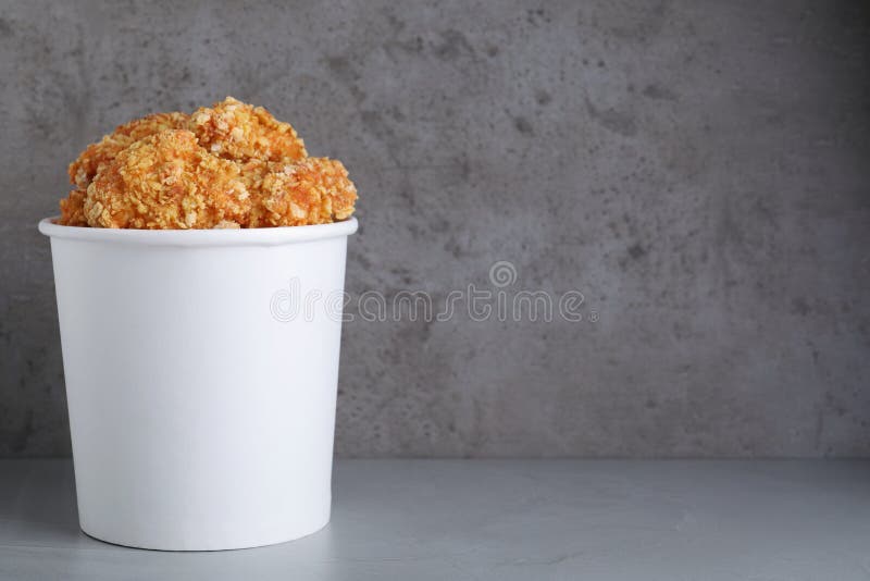 Bucket with Yummy Nuggets on Table, Space for Text Stock Photo - Image ...