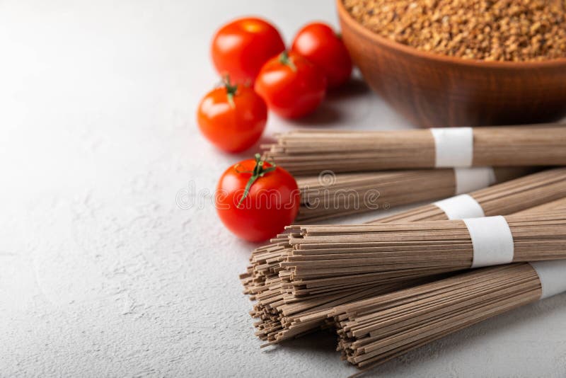 Buckwheat Soba Paste and Cherry Tomatoes on a Textured Background ...