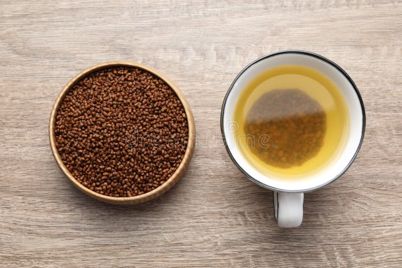 Buckwheat Tea in Cup and Bowl with Granules on Wooden Table, Flat Lay ...