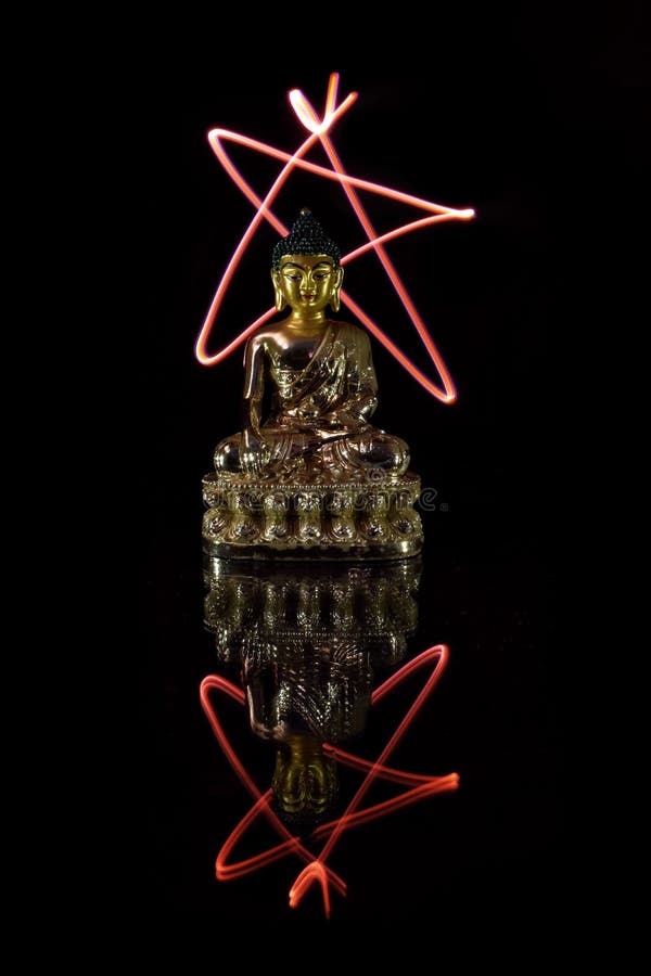 Buddha Statue on a Glass with a Star Painted Black Background and ...