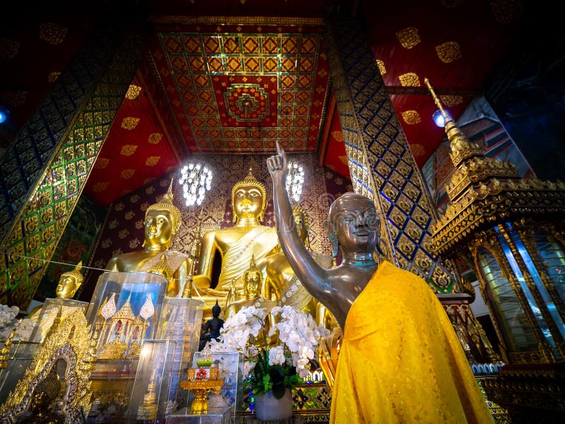 Buddha Statue Stands Pointing Up Behind the Big Buddha Statues Stock ...