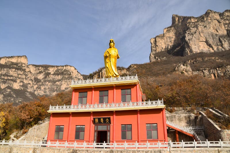 A Buddhist Temple with Gold Statue in the Mountains at Yuntaishan in ...
