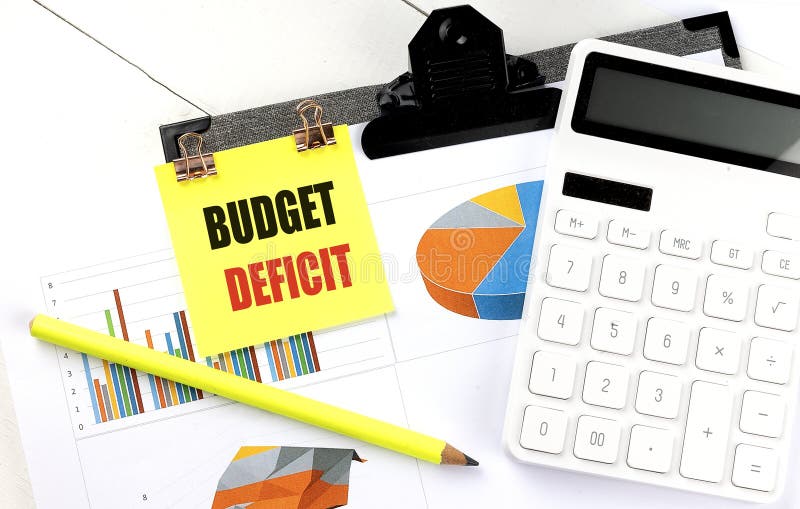 BUDGET DEFICIT Text on Yellow Sticky with Calculator, Pencil and Chart ...