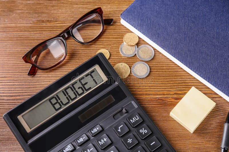 Budget Plan. Calculator, Glasses, Coins and Notebook on Wooden Table ...