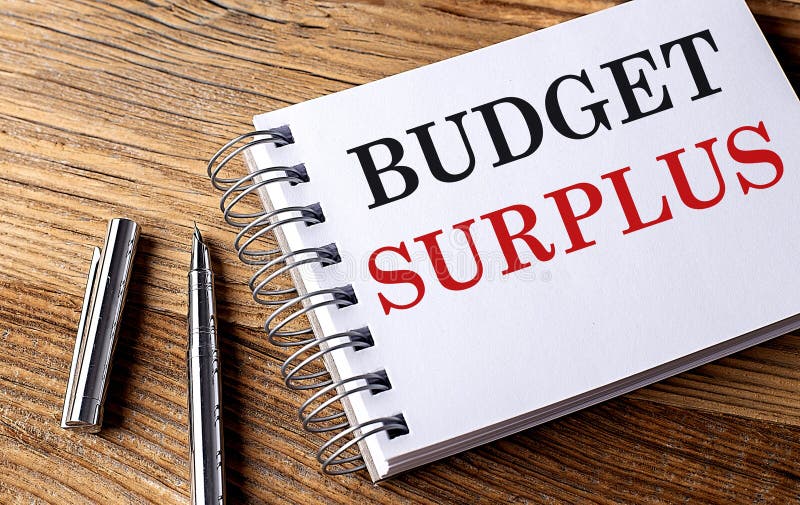 BUDGET SURPLUS Text on Notebook with Pen on the Wooden Background Stock ...