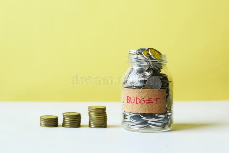 Budget Text on a Saving Coins Against Yellow Background Stock Image ...
