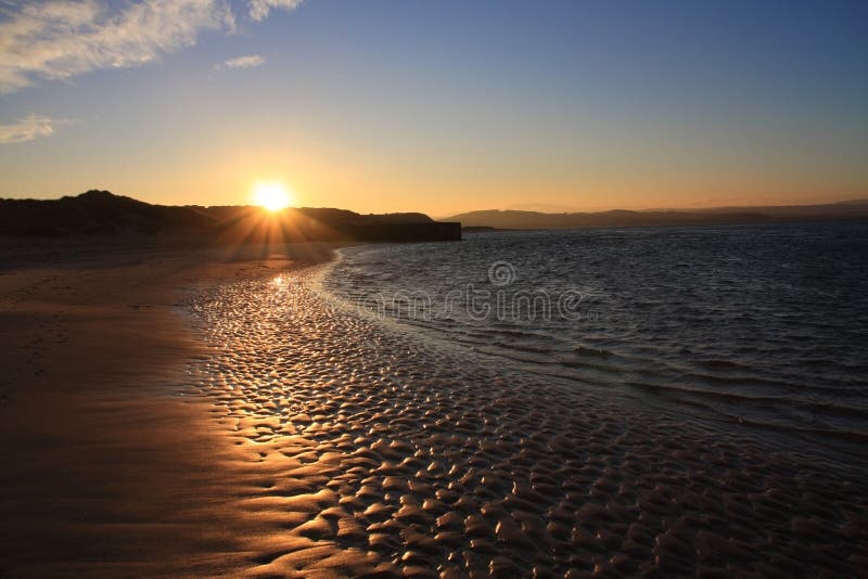 Budle Bay sunset stock image. Image of footprints, sand - 3900191