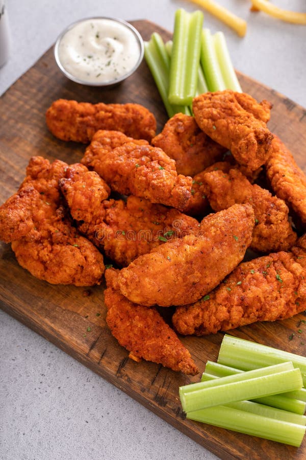 Buffalo Chicken Strips on a Board with Ranch and Celery Stock Photo ...