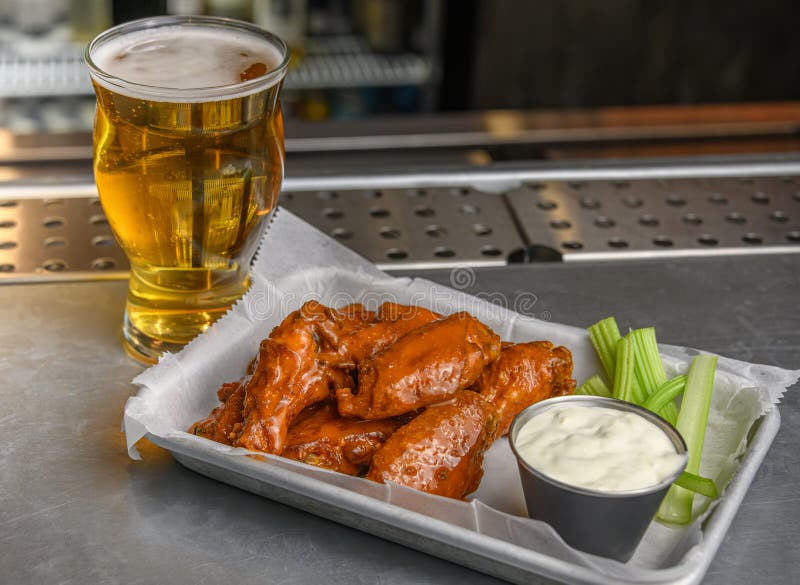 Buffalo Style Chicken Wings and a Draft Beer Stock Image - Image of ...