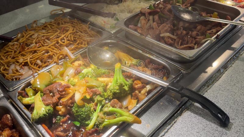 A Buffet Selection Featuring Various Asian Dishes, Including Stir-fried ...