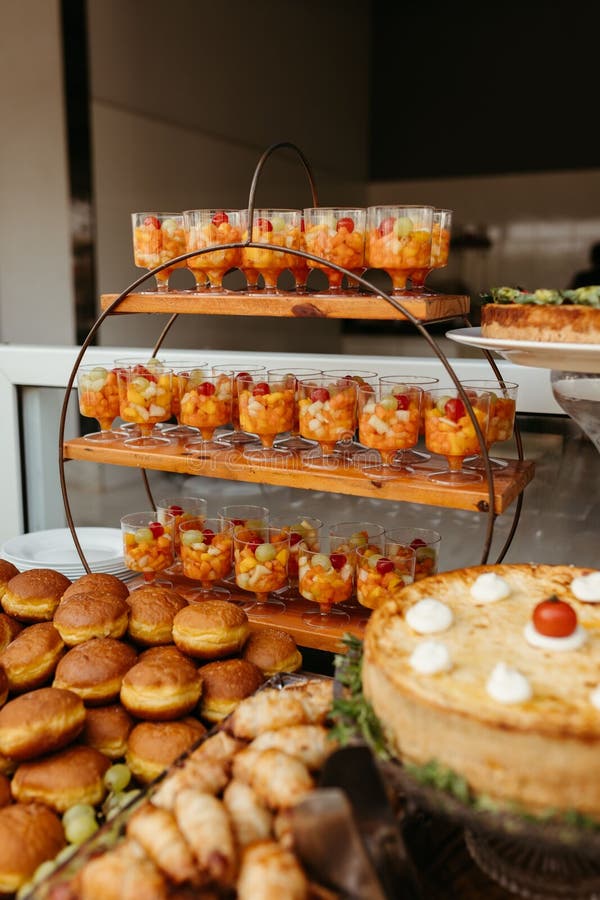 Buffet Table with Assorted Pastries, Fruit Cups, and Cheesecake. Stock ...