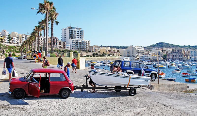 Two Men are Pulling a Boat Ashore with the Help of a Small Car ...