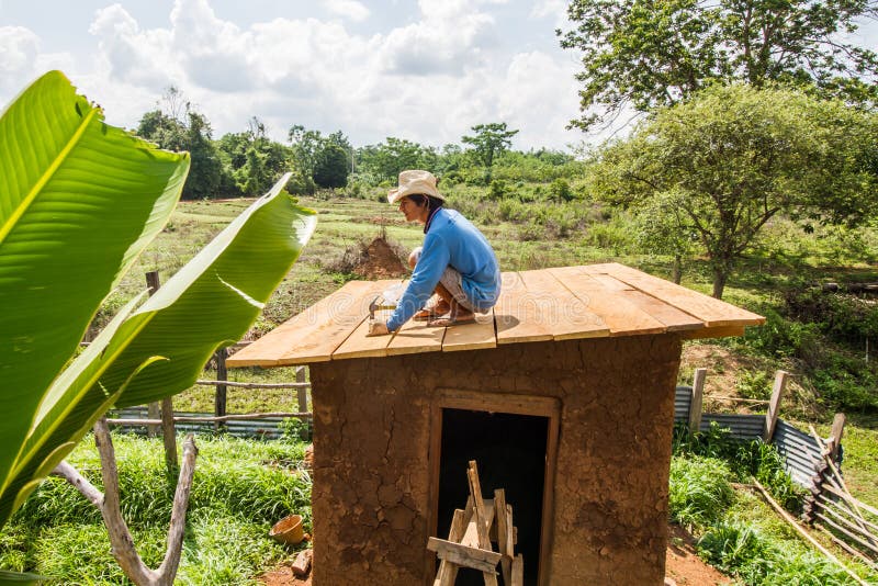 Mud house roof making stock image. Image of earthquake - 117276649