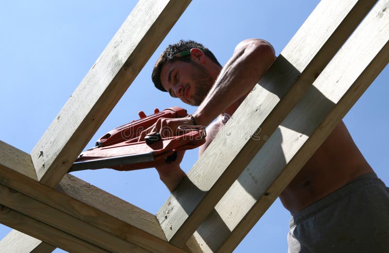 Hispanic Carpenter Lifting Roofing Panels Onto Roof Stock Image - Image ...