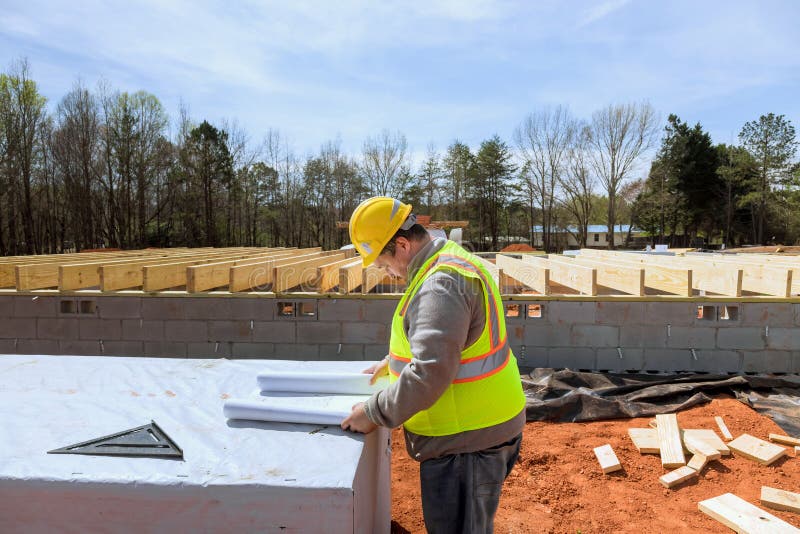 A Build Engineer Checks Construction of New Home Using Construction ...