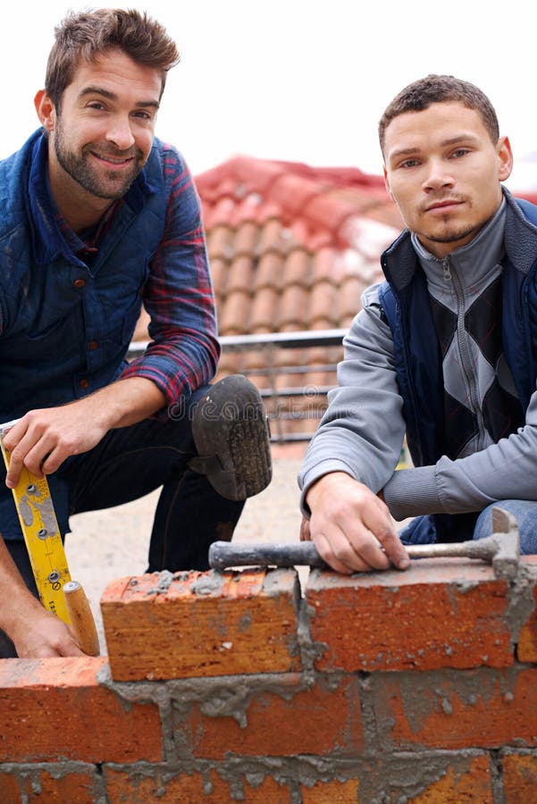 We Build Solid Walls. Portrait of a Bricklayer and His Apprentice at ...