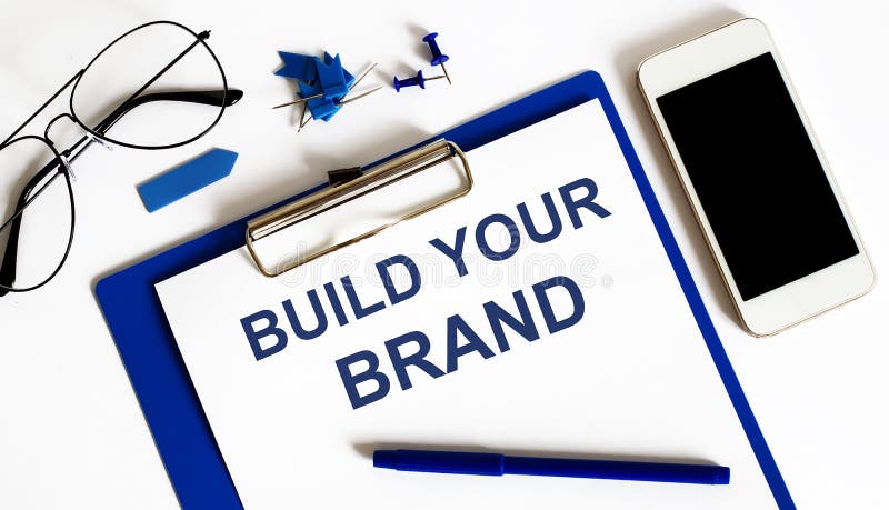 BUILD YOUR BRAND Text on the Paper with Office Tools Stock Photo ...