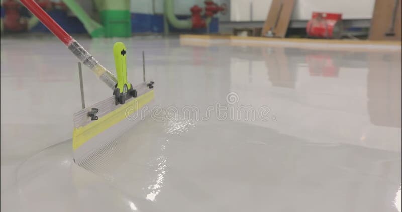 A Builder is Applying Polymer Floors Using Scraper Float. a Builder ...