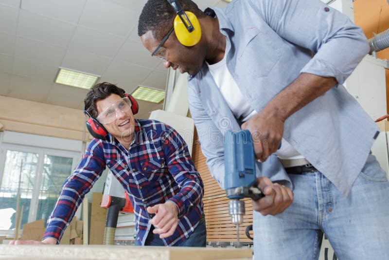 Builder and Apprentice Carrying Wood on Construction Site Stock Image ...