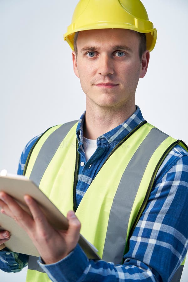 Studio Portrait of Builder Architect Holding Clipboard Against White ...