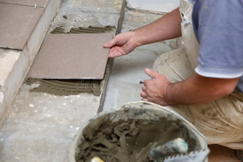 The Builder Arranges Ceramic Tiles on the Stairs Inside the Building ...
