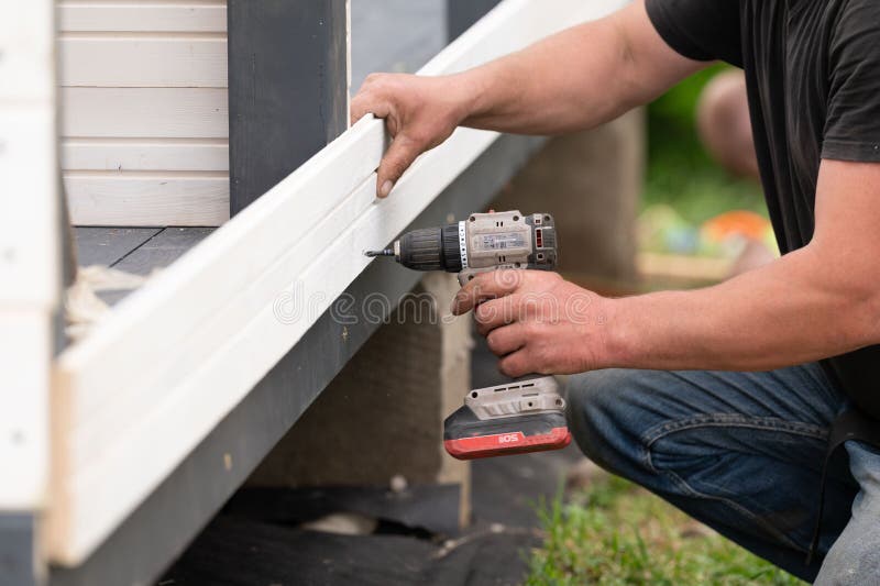 The Builder Attaches the Wall To the Gazebo Frame Using Screws and a ...