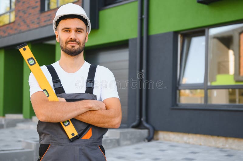 Builder on the Background of New Cottages. the Concept of the ...