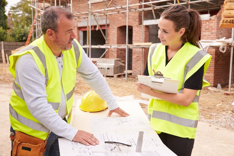 Builder on Building Site Discussing Work with Apprentice Stock Image ...