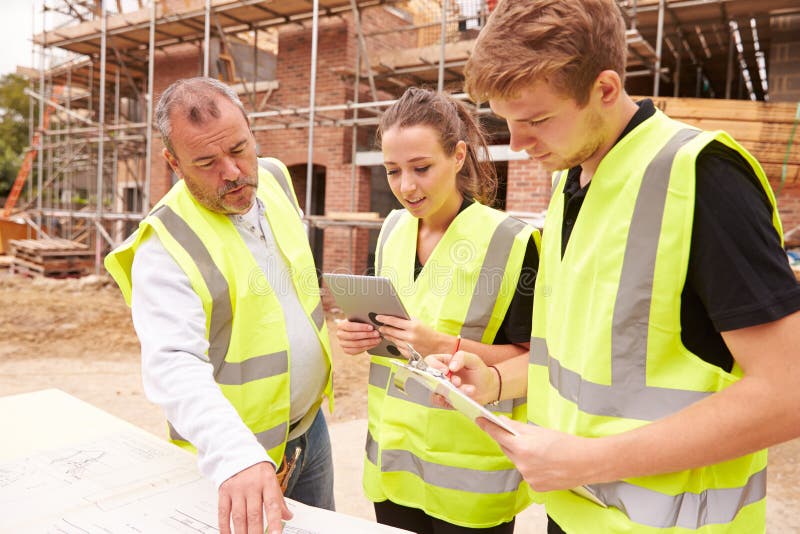 Builder and Apprentice Carrying Wood on Construction Site Stock Image ...