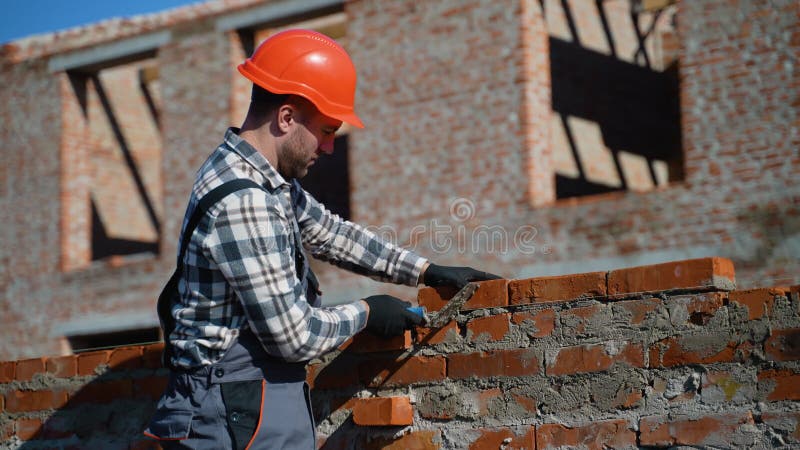Builder Carefully Laying Bricks at Construction Site Stock Footage ...