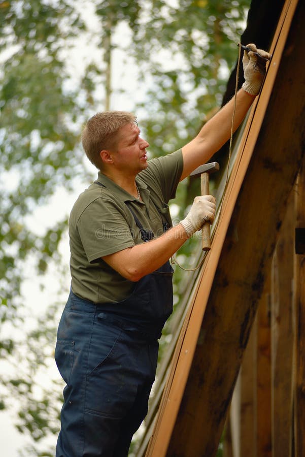 Builder or Carpenter Working and Builds a Roof Stock Photo - Image of ...