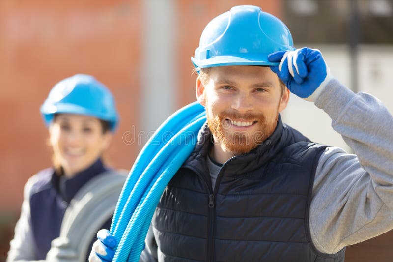 Builder Carrying Reel Blue Pipe on Shoulder Stock Photo - Image of blue ...