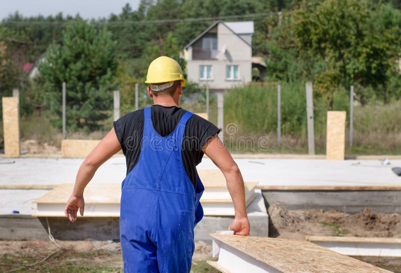 Builder Carrying Wall Insulation Stock Photo - Image of skilled ...