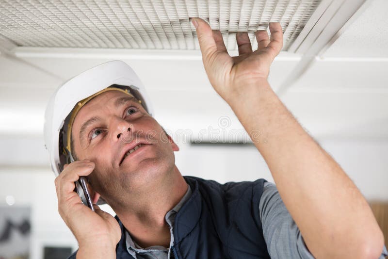 Builder on Cell Phone Checking Ceiling State Stock Image - Image of ...