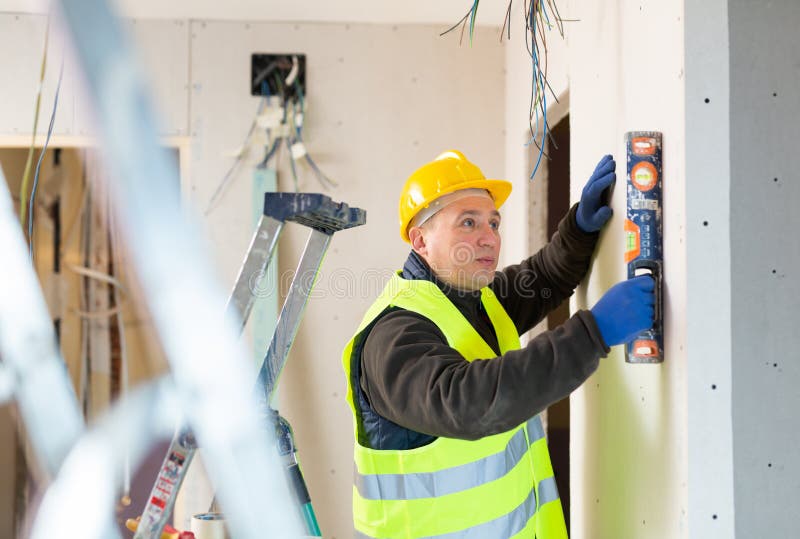 Builder Checks the Vertical of the Wall Using Level Stock Image - Image ...